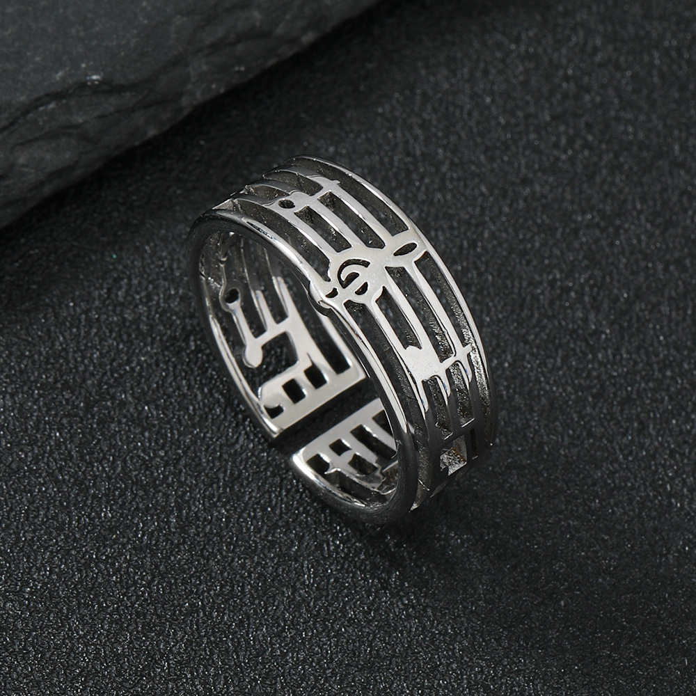 Fashion personality titanium steel ring men and women's hollow staff ...
